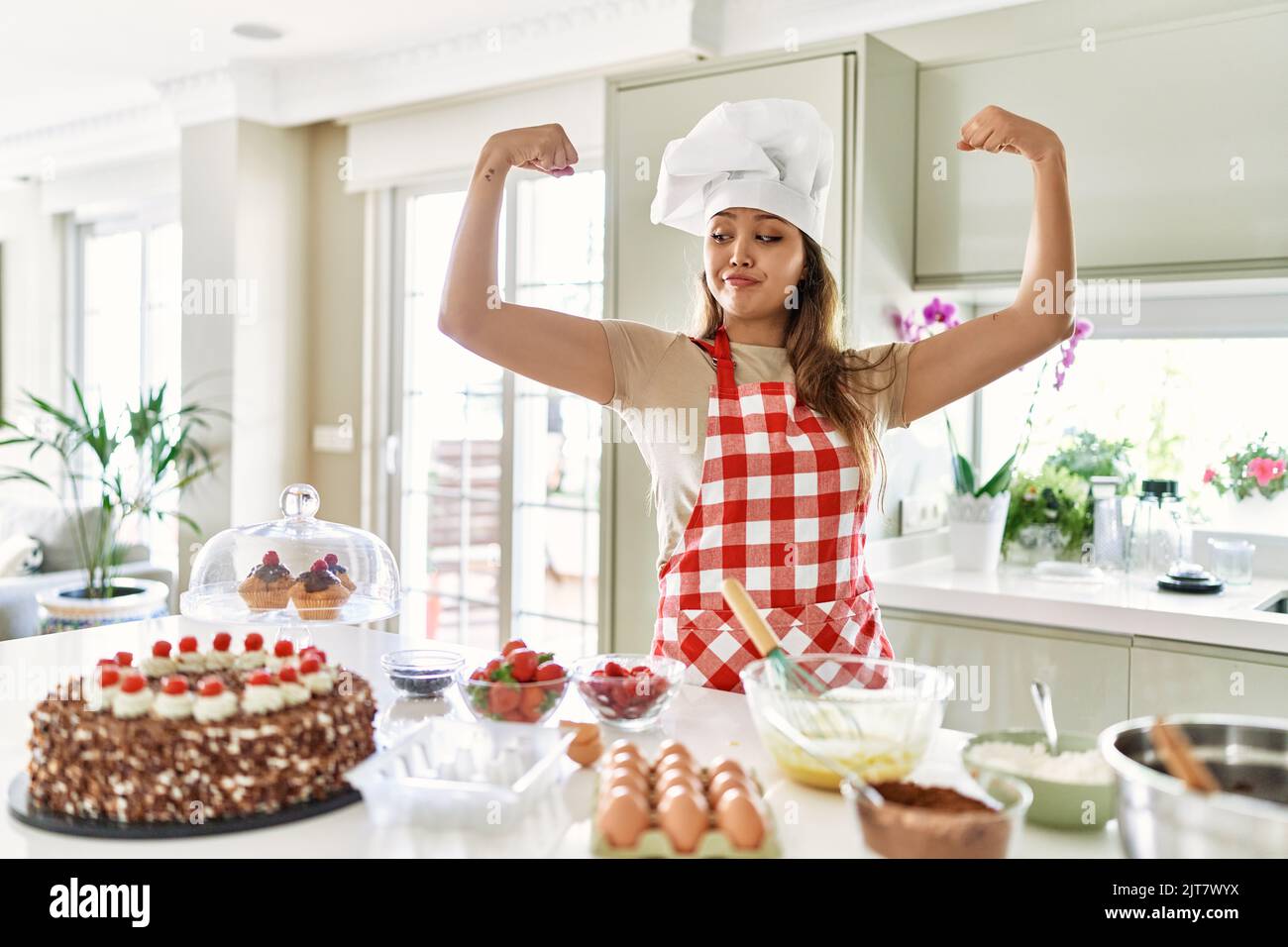Beautiful young brunette pastry chef woman cooking pastries at the ...