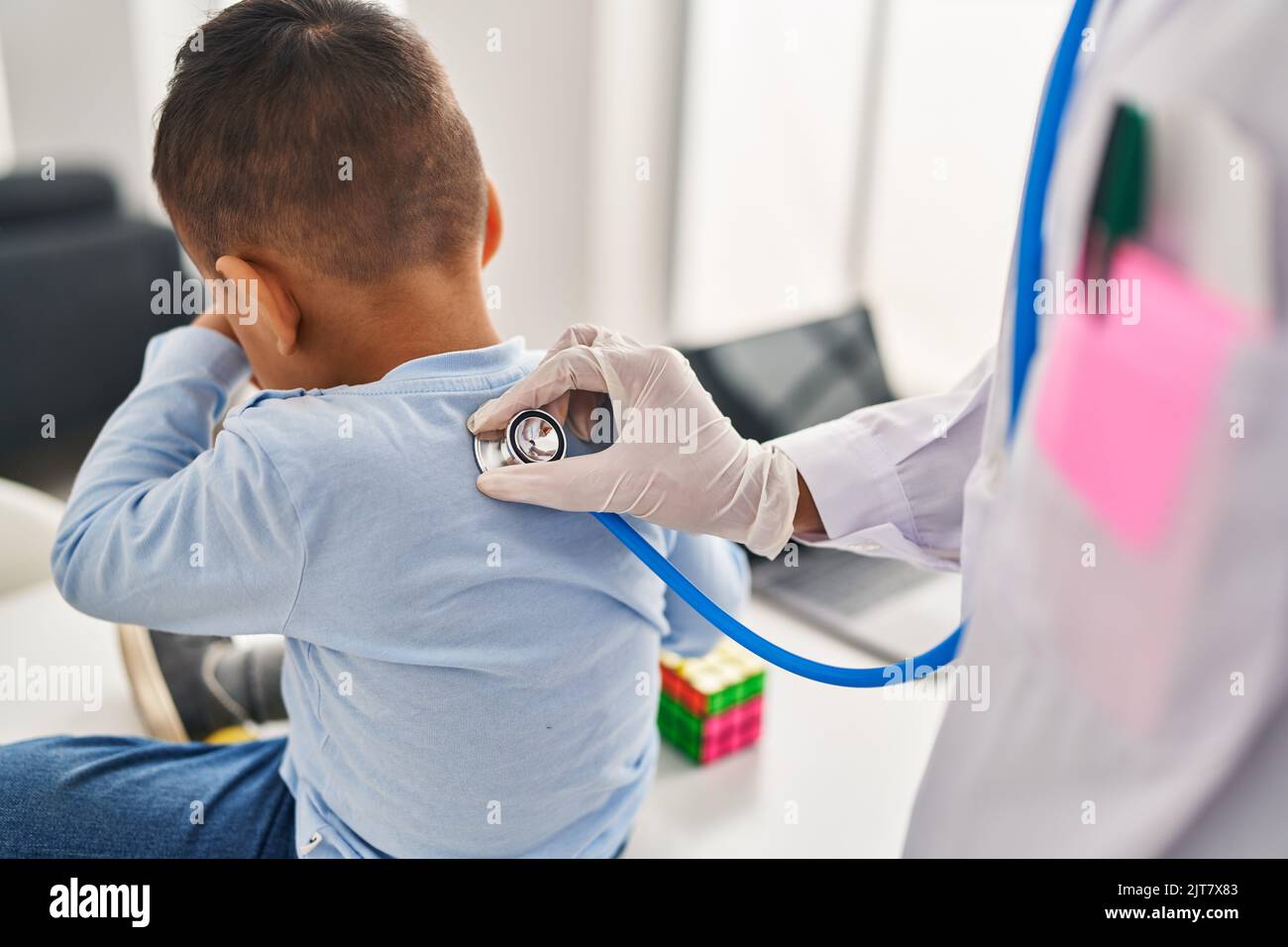 Mother and son pediatrician and patient auscultating respiratory system at clinic Stock Photo ...