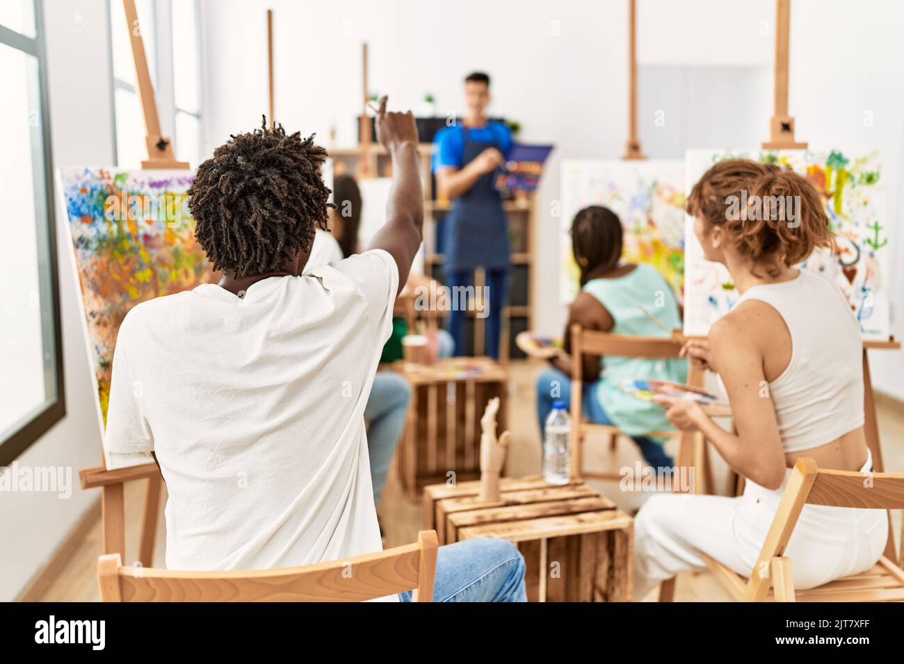 Group of people smiling happy drawing in paint class at art studio ...