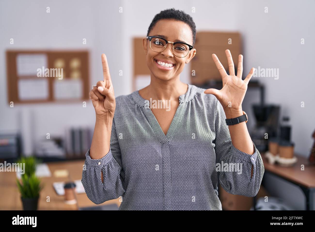 African american woman working at the office wearing glasses showing ...