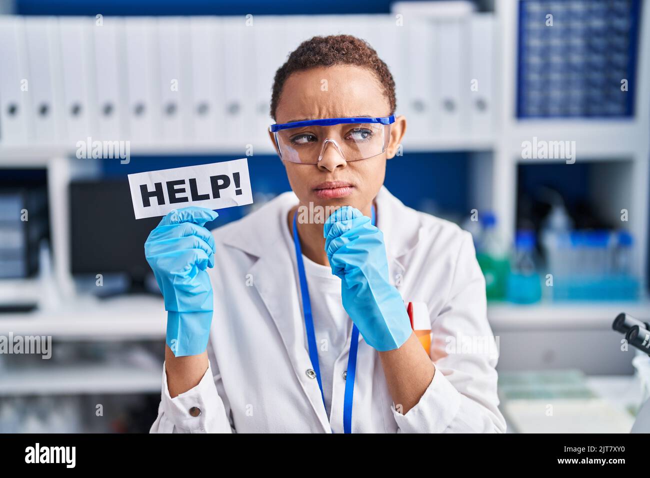 Beautiful african american woman working at scientist laboratory asking ...