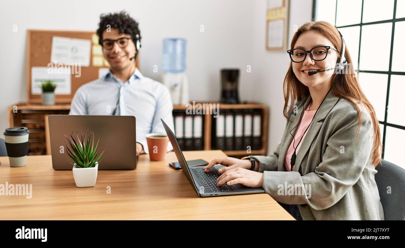 Two call center agent smiling happy working at the office Stock Photo ...