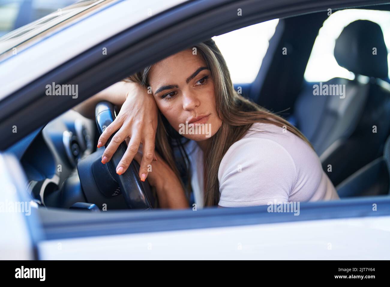 Young woman driving car at street Stock Photo - Alamy
