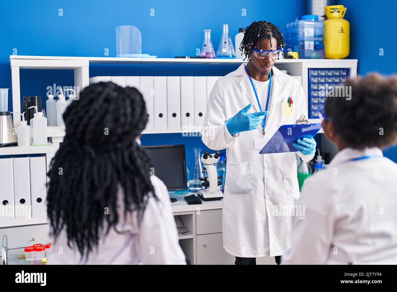 African american friends scientists explaining experiment at laboratory ...