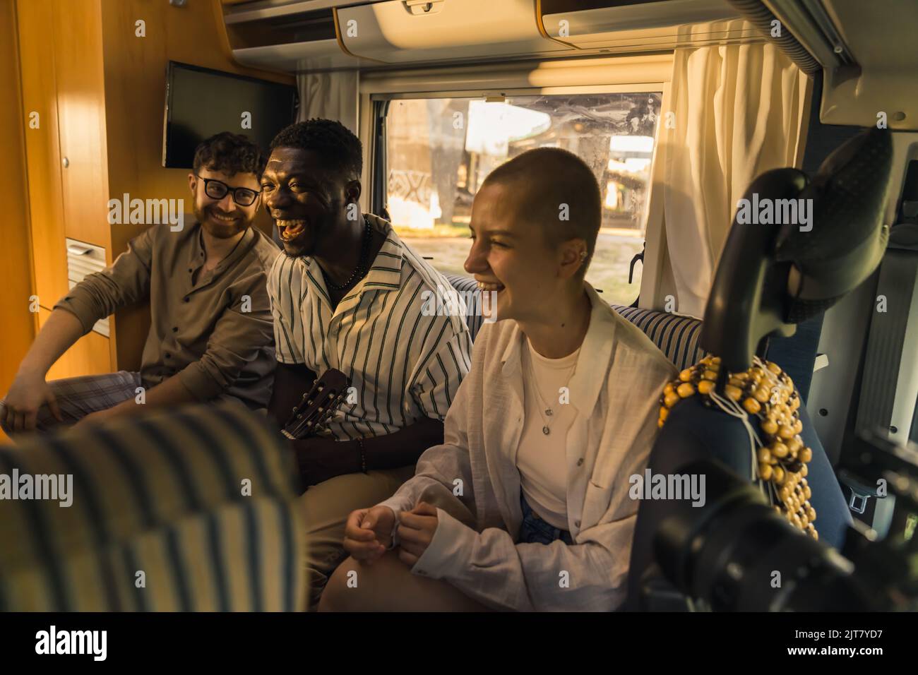 multiracial friends having fun in the van, medium shot travel and ...