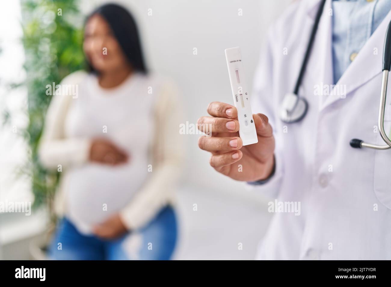 Young latin couple doctor and patient having medical consultation ...