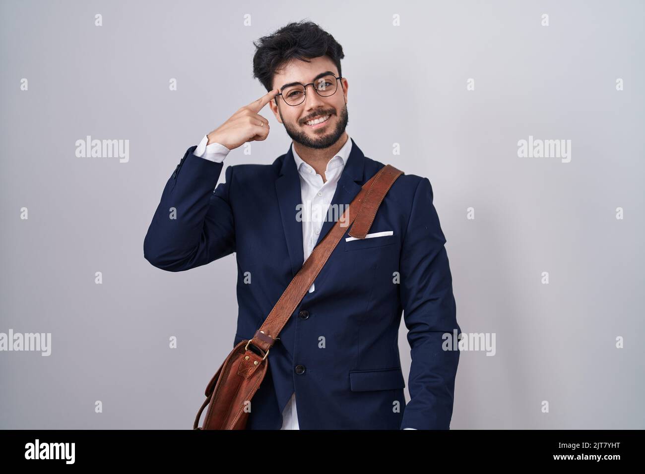 Hispanic man with beard wearing business clothes smiling pointing to ...