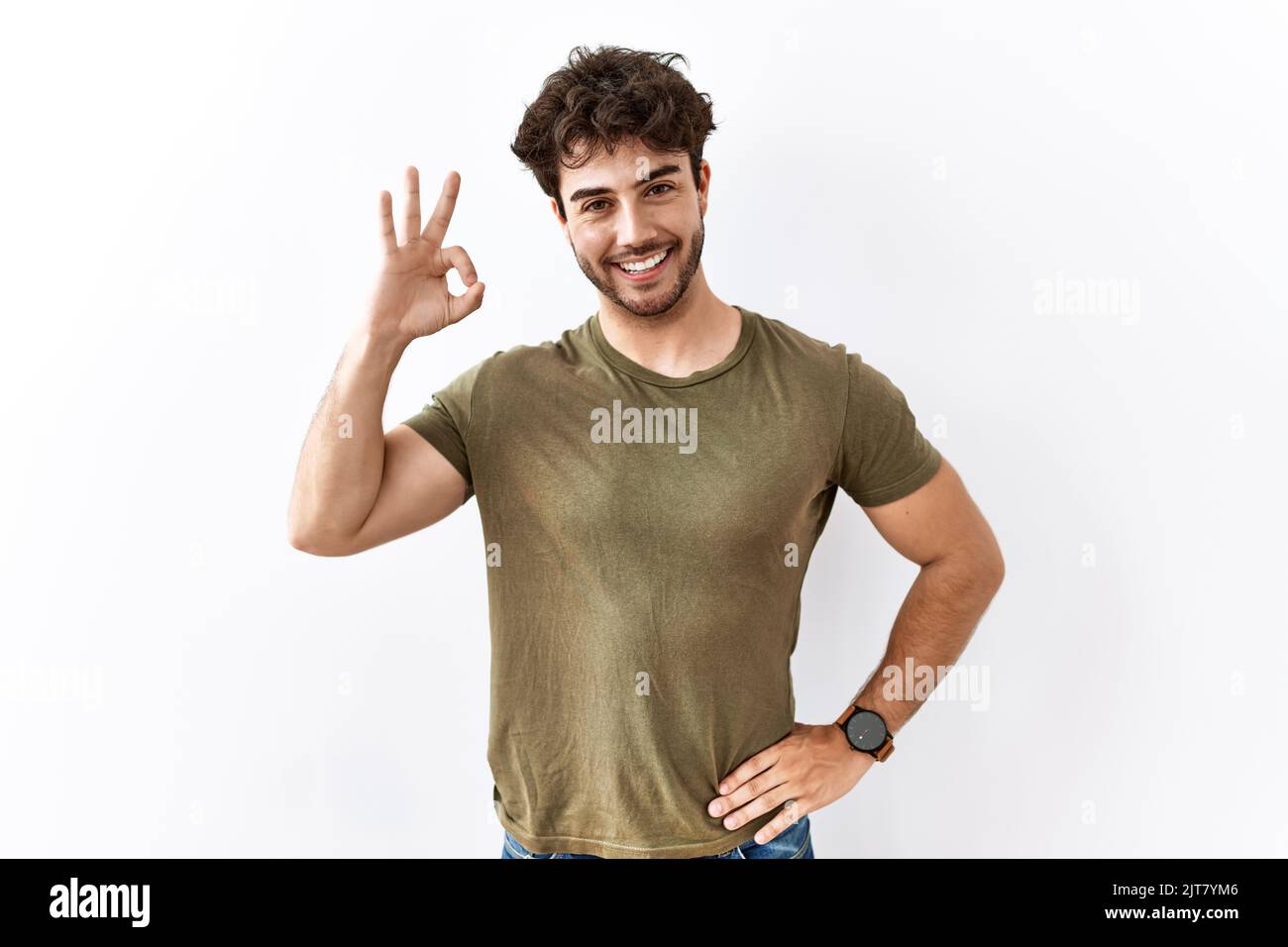 Hispanic man standing over isolated white background smiling positive ...