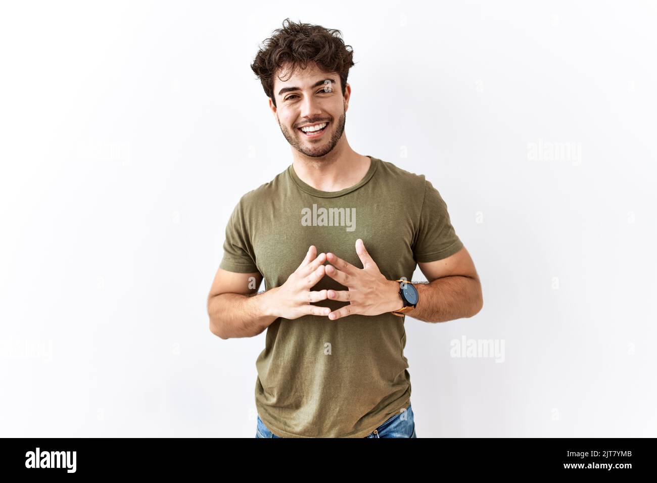 Hispanic man standing over isolated white background hands together and ...