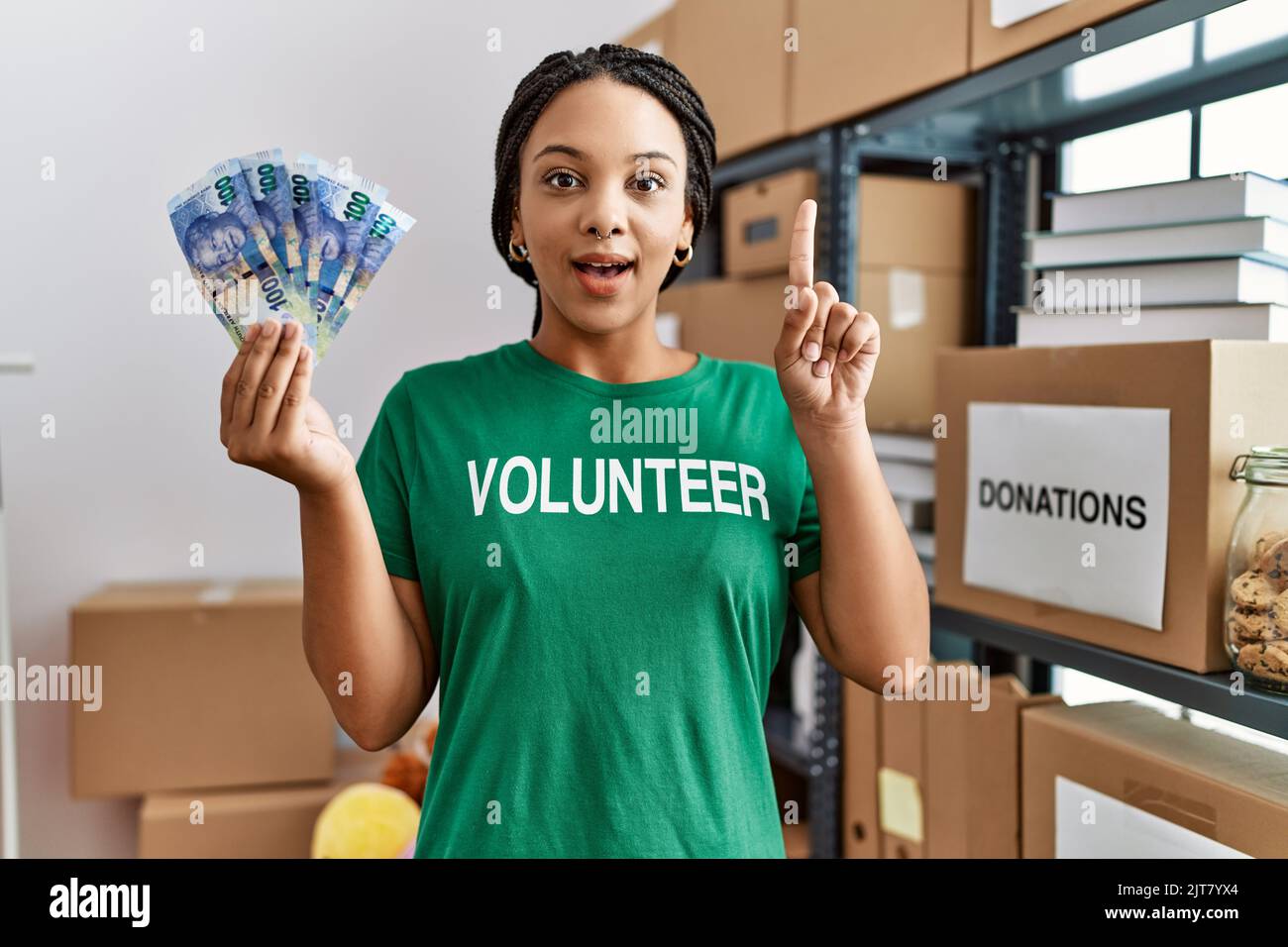 Young african american woman wearing volunteer t shirt holding african ...