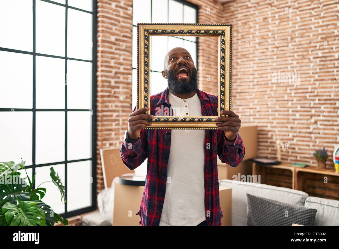 African american man putting face in empty frame angry and mad ...