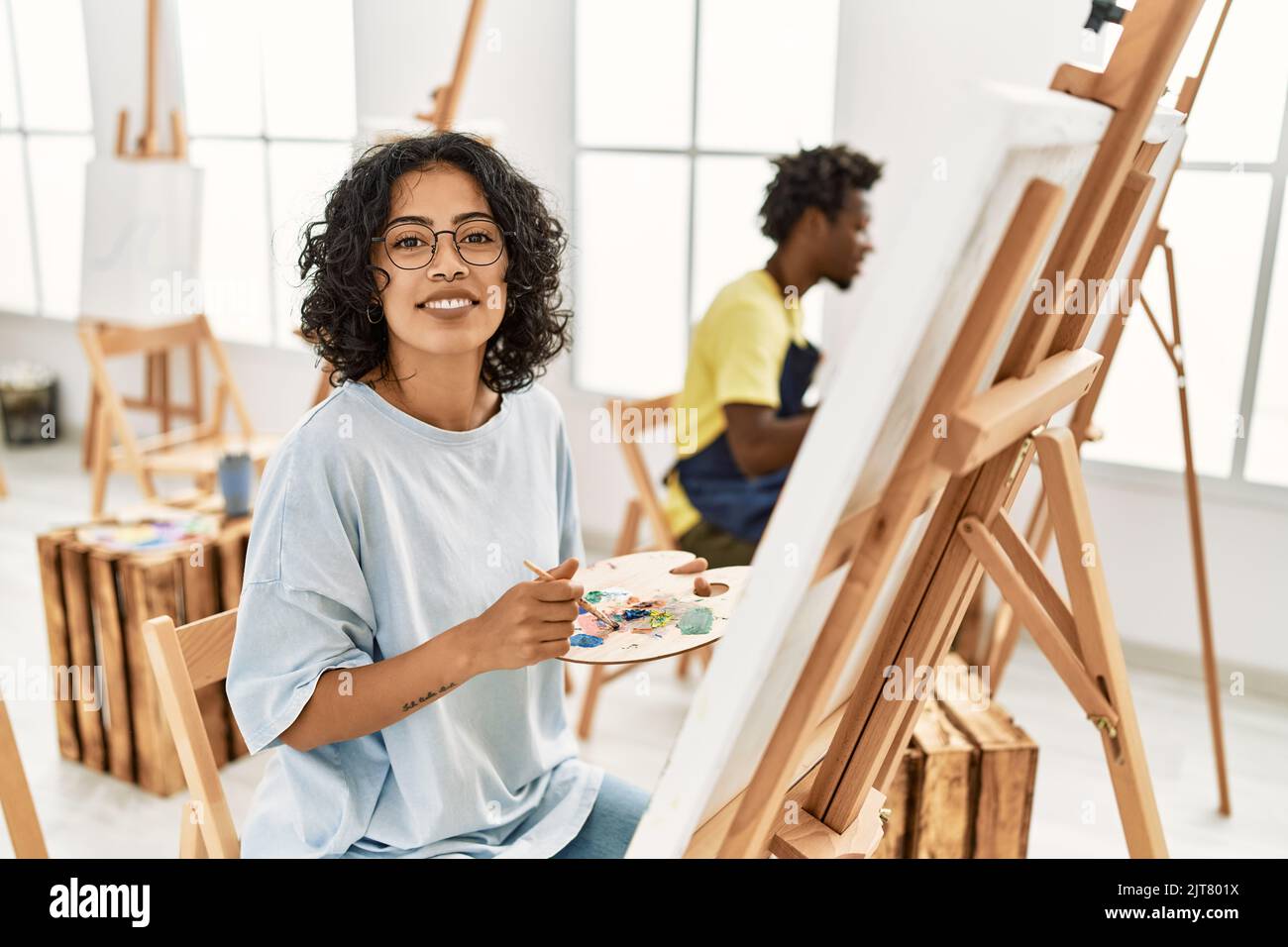 African american artist couple smiling happy painting at art studio ...