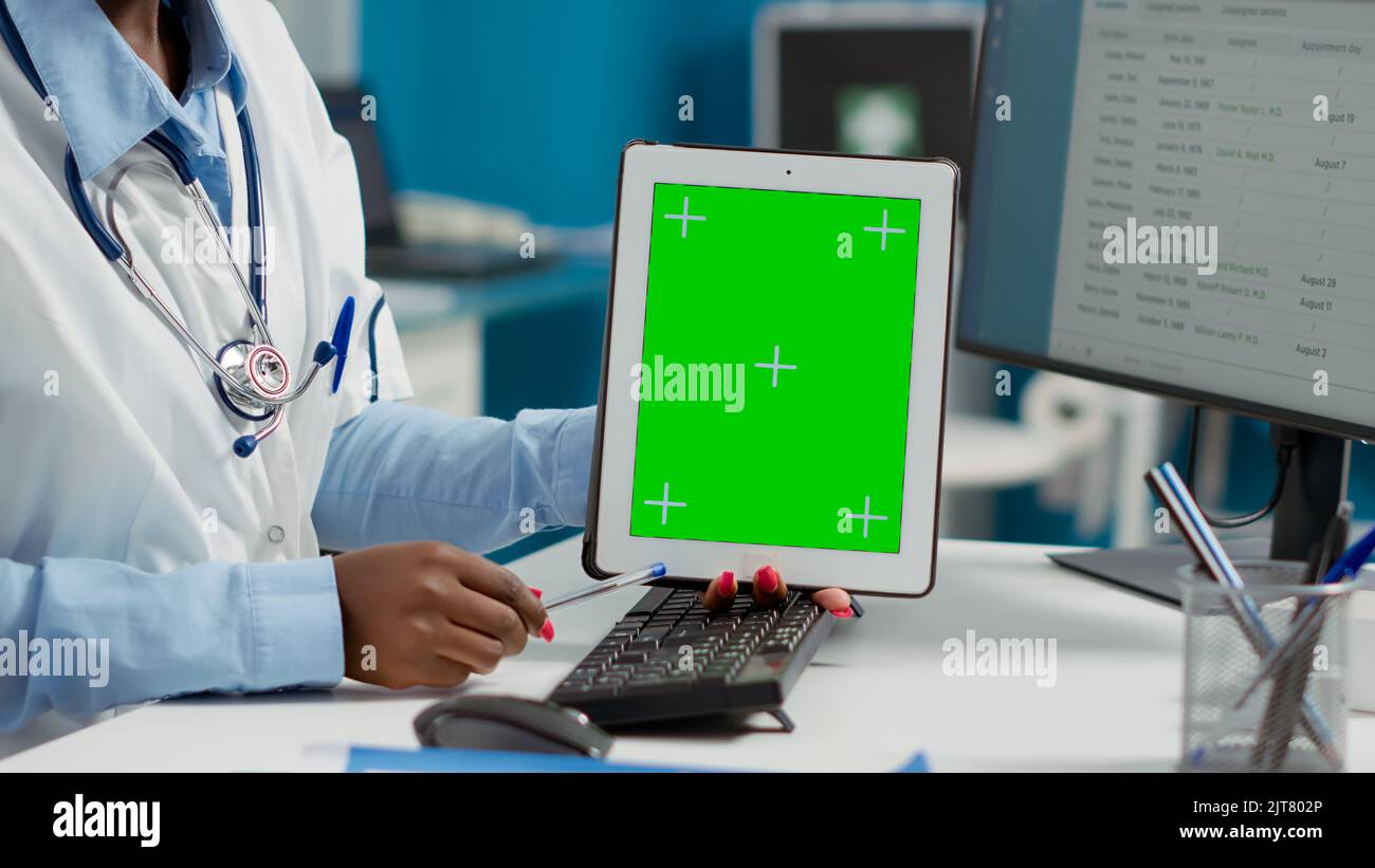 Female doctor holding tablet with greenscreen at checkup with paralyzed ...
