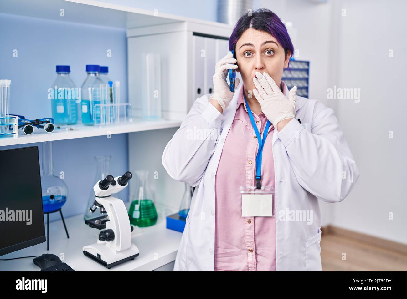 Plus size woman wit purple hair working at scientist laboratory ...