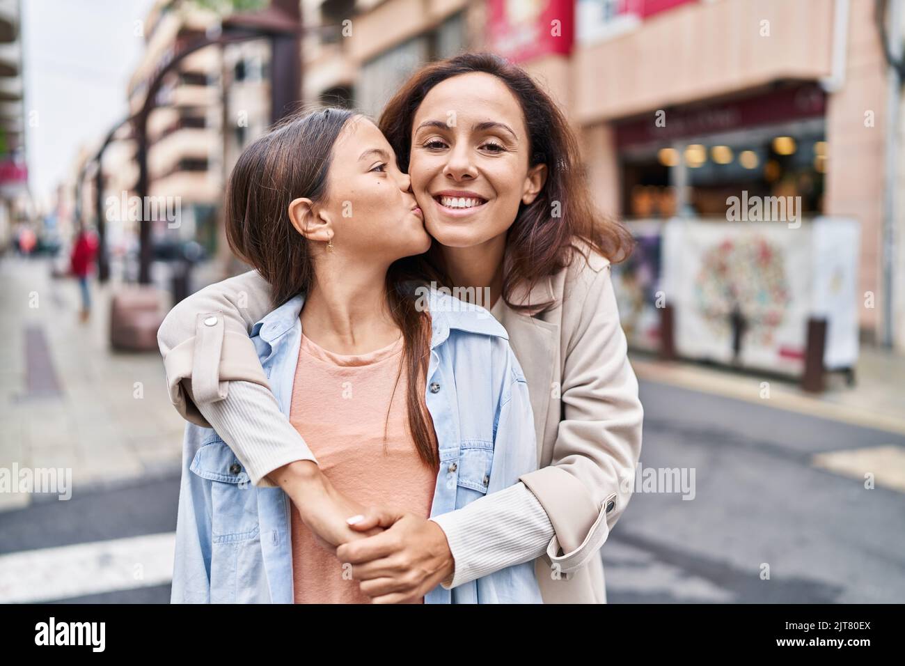 Woman And Girl Mother And Daughter Hugging Each Other And Kissing At