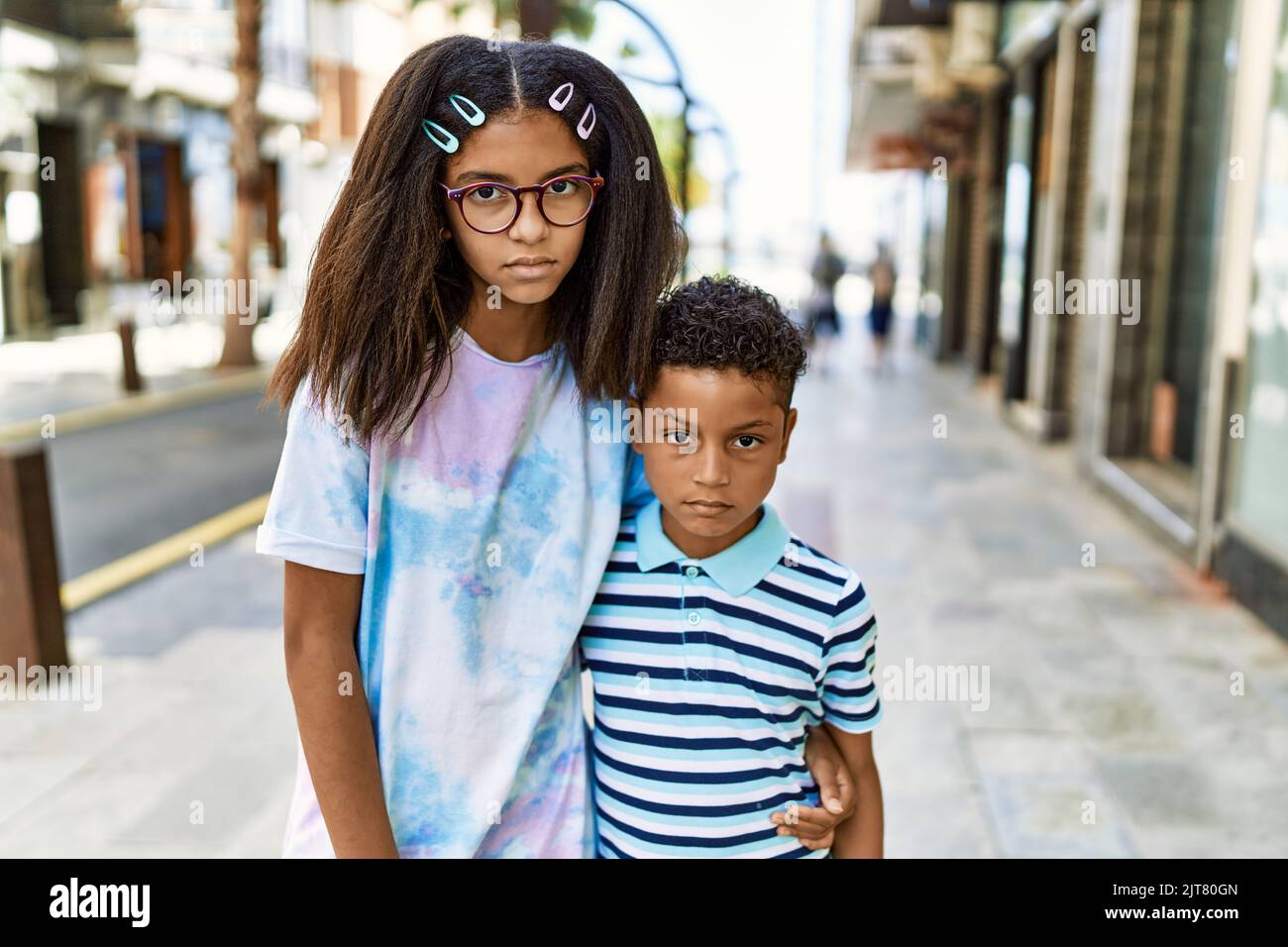 African american family of bother and sister standing at the street ...