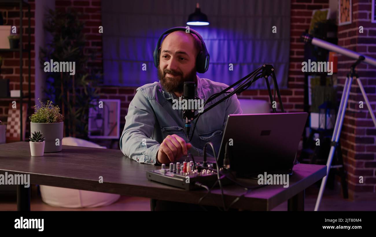 Man vlogger filming video with podcast equipment in studio recording ...