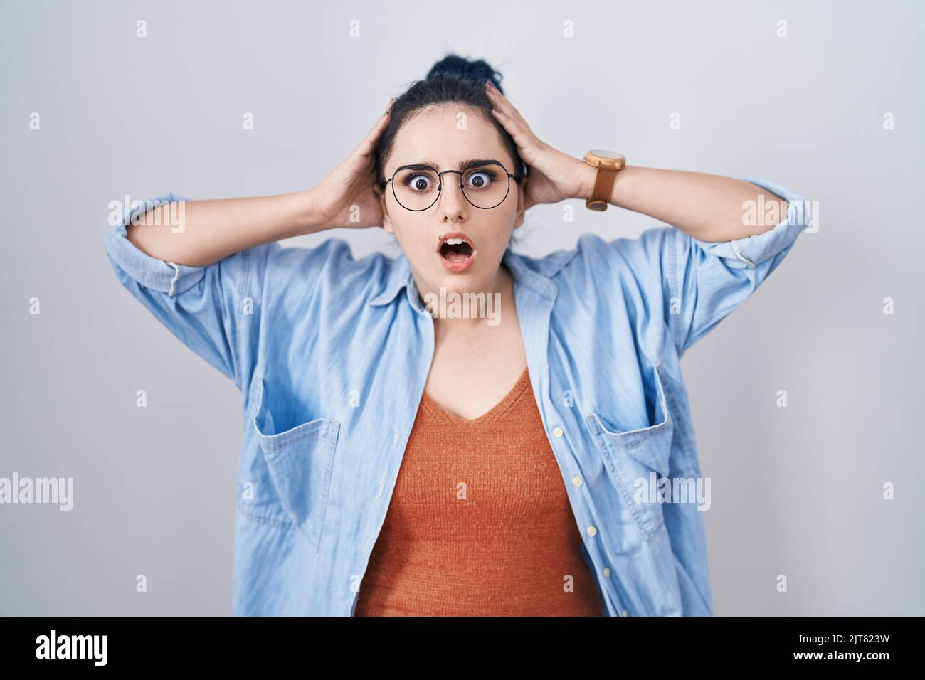 Young modern girl with blue hair standing over white background crazy ...