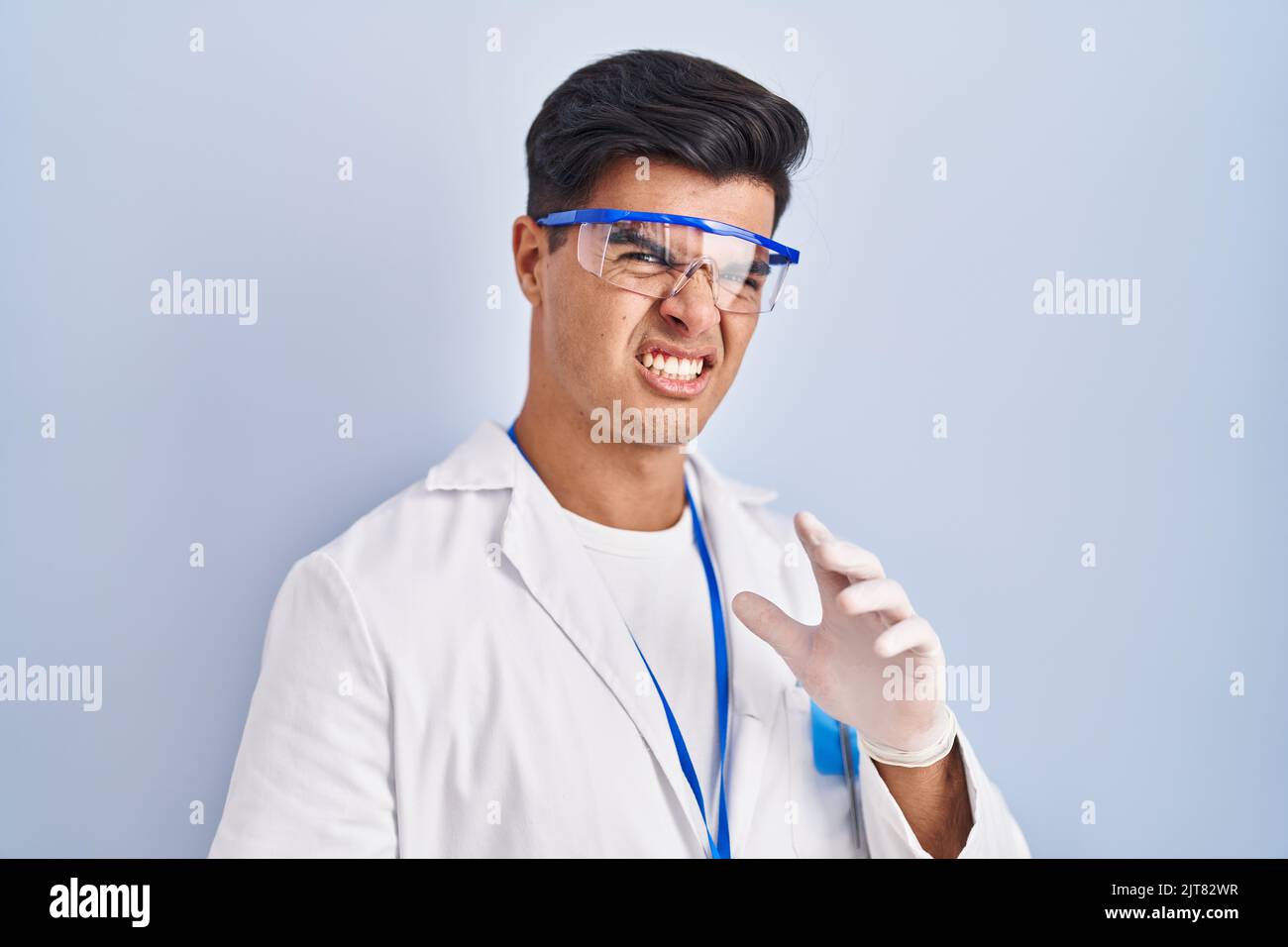Hispanic man working as scientist disgusted expression, displeased and ...