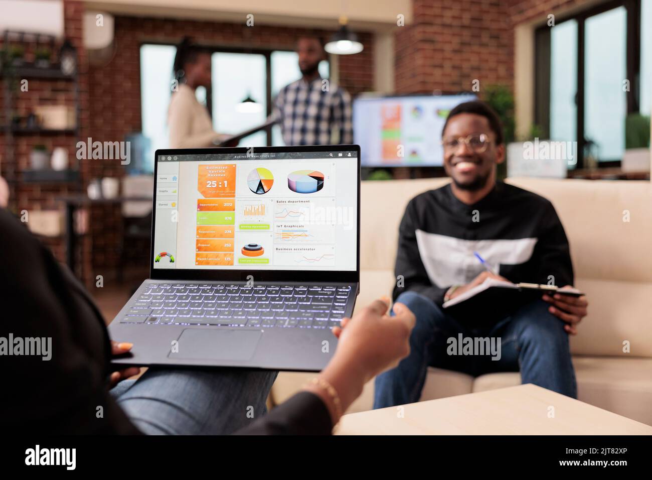 Office coworkers working on data charts with research information ...