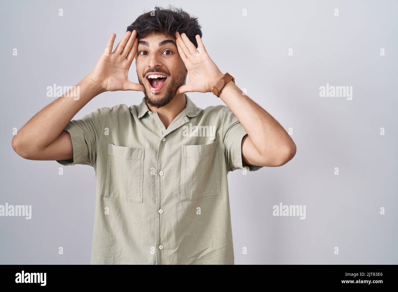 Arab man with beard standing over white background smiling cheerful ...