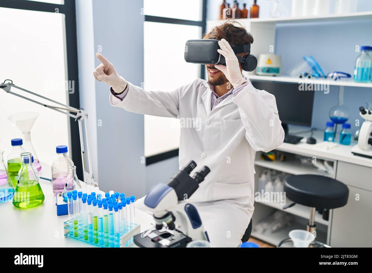 Young arab man scientist using virtual reality glasses working at ...