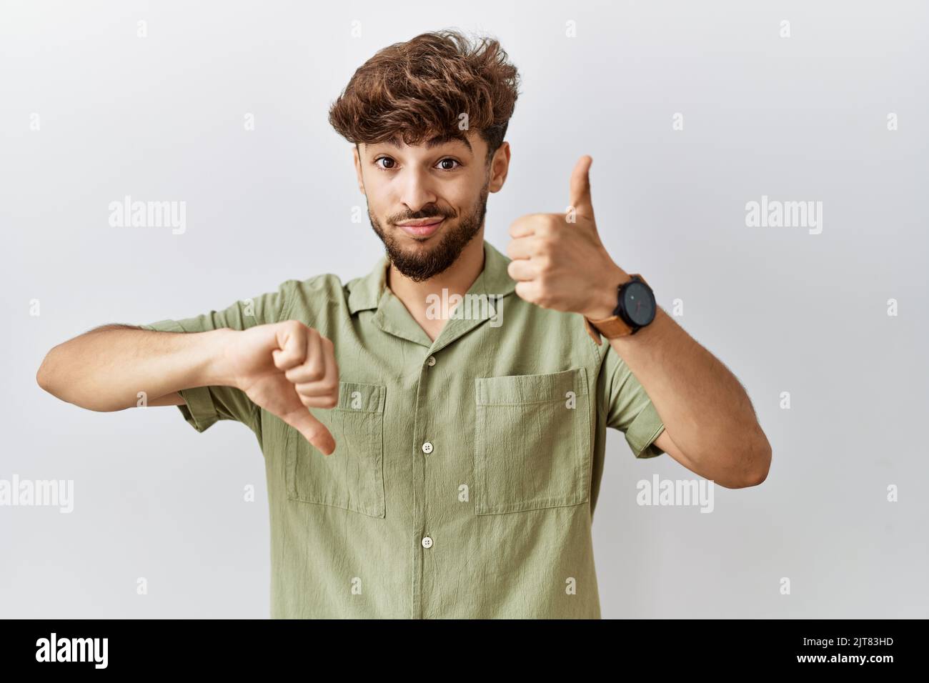 Young arab doctor man standing over isolated background doing thumbs up ...