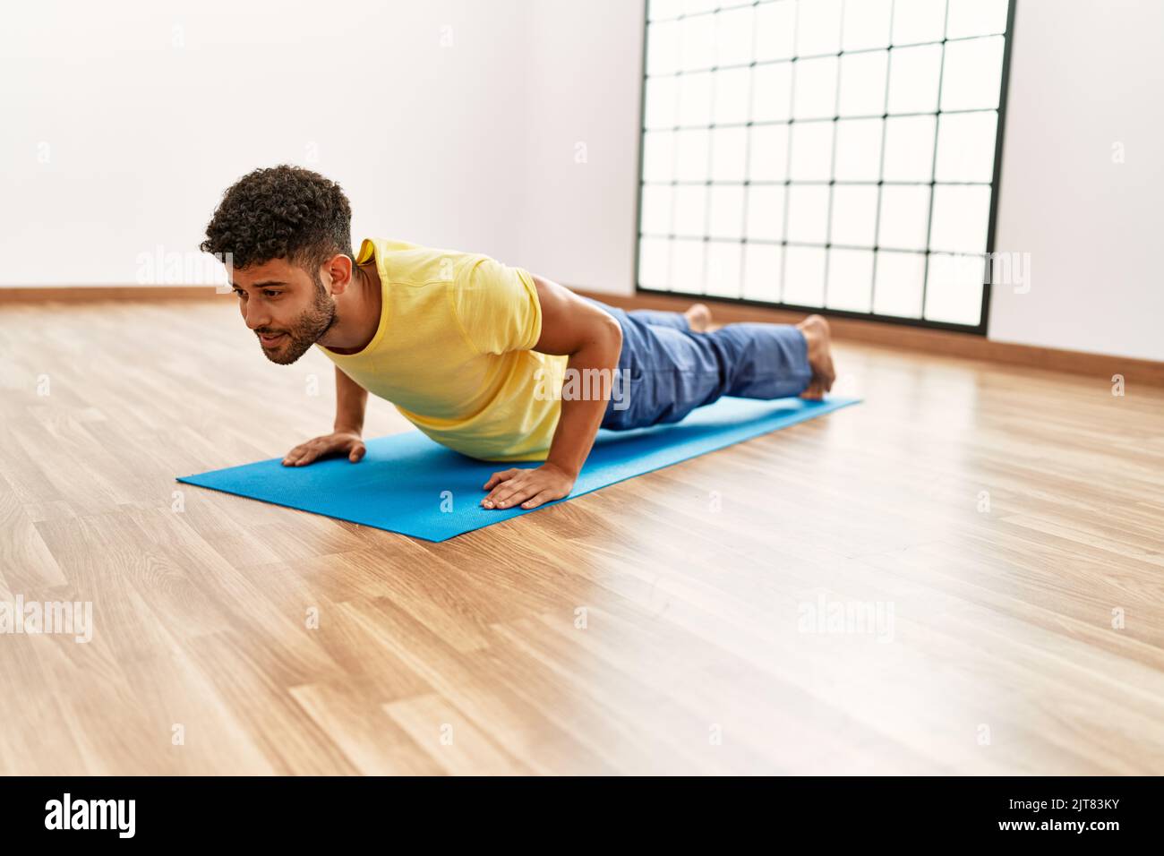 Young arab sporty man concentrate training abs exercise at sport center ...