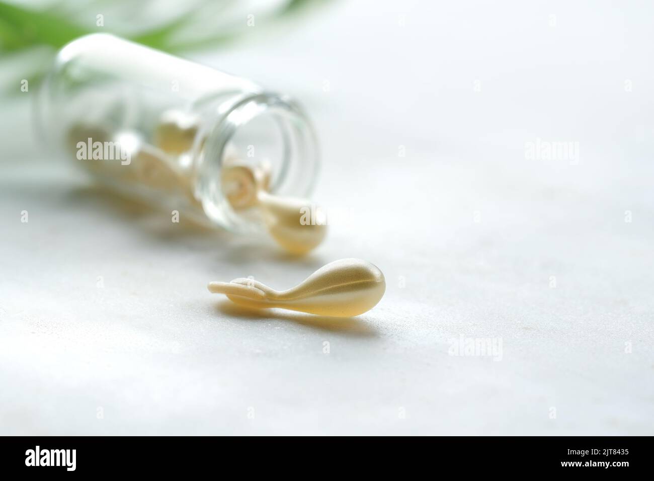 Serum capsules for healthy skin. Close-up on transparent bottle with ...
