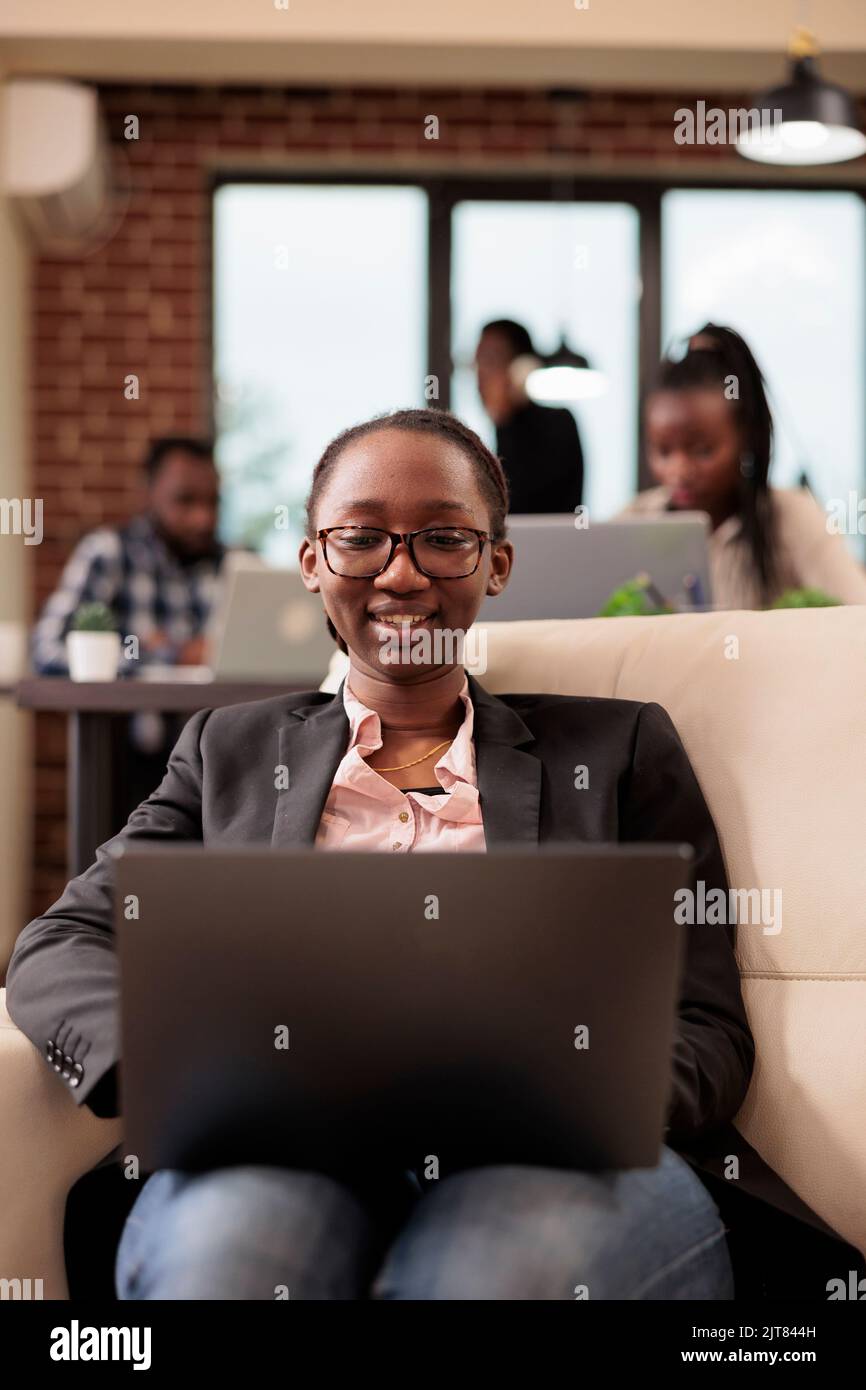 Female freelancer working on laptop in office, browsing internet to ...