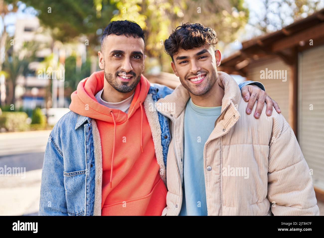 Two man couple hugging each other standing at street Stock Photo - Alamy
