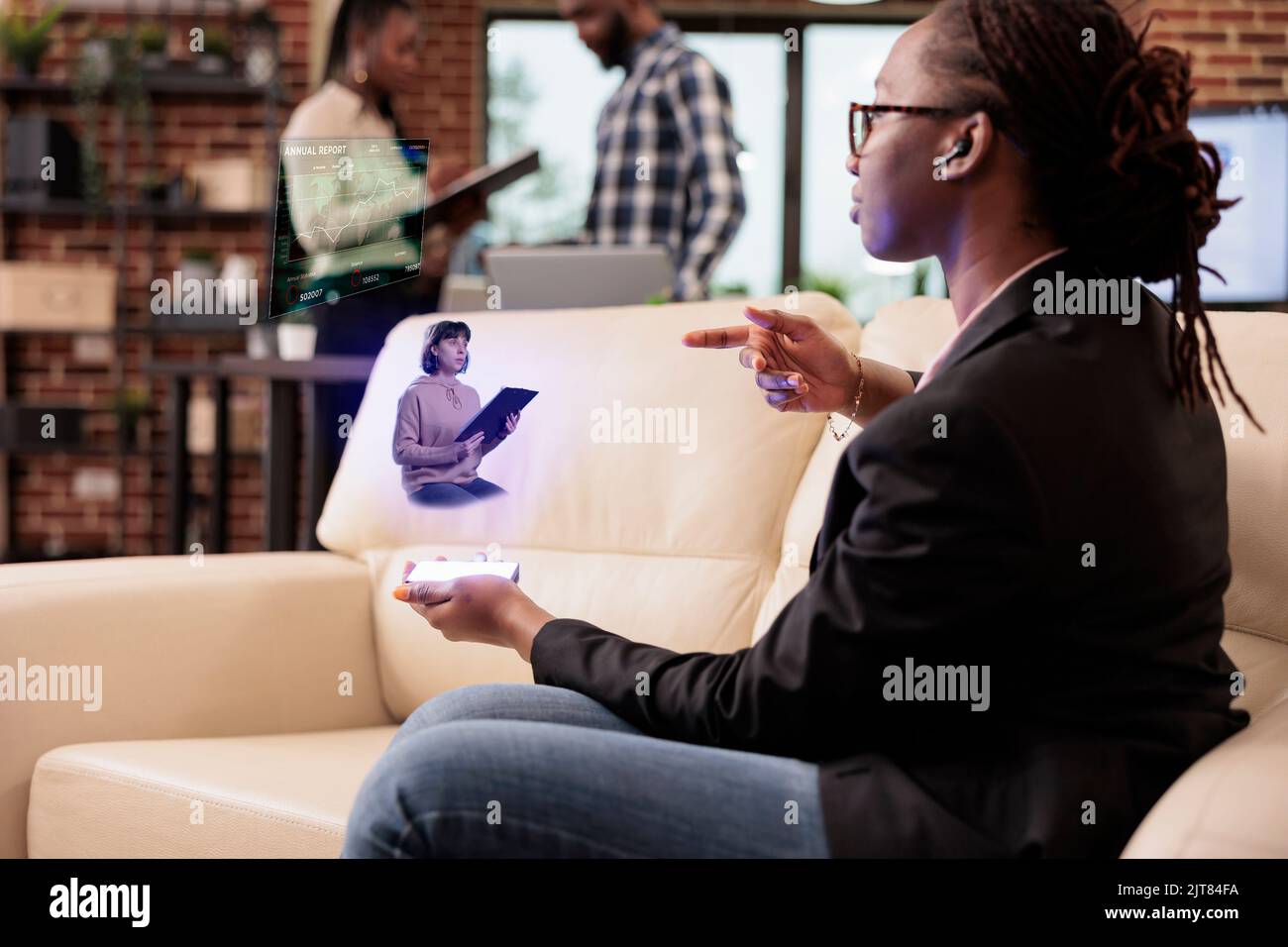 Startup worker talking to ai hologram, using artificial intelligence and augmented reality to ...