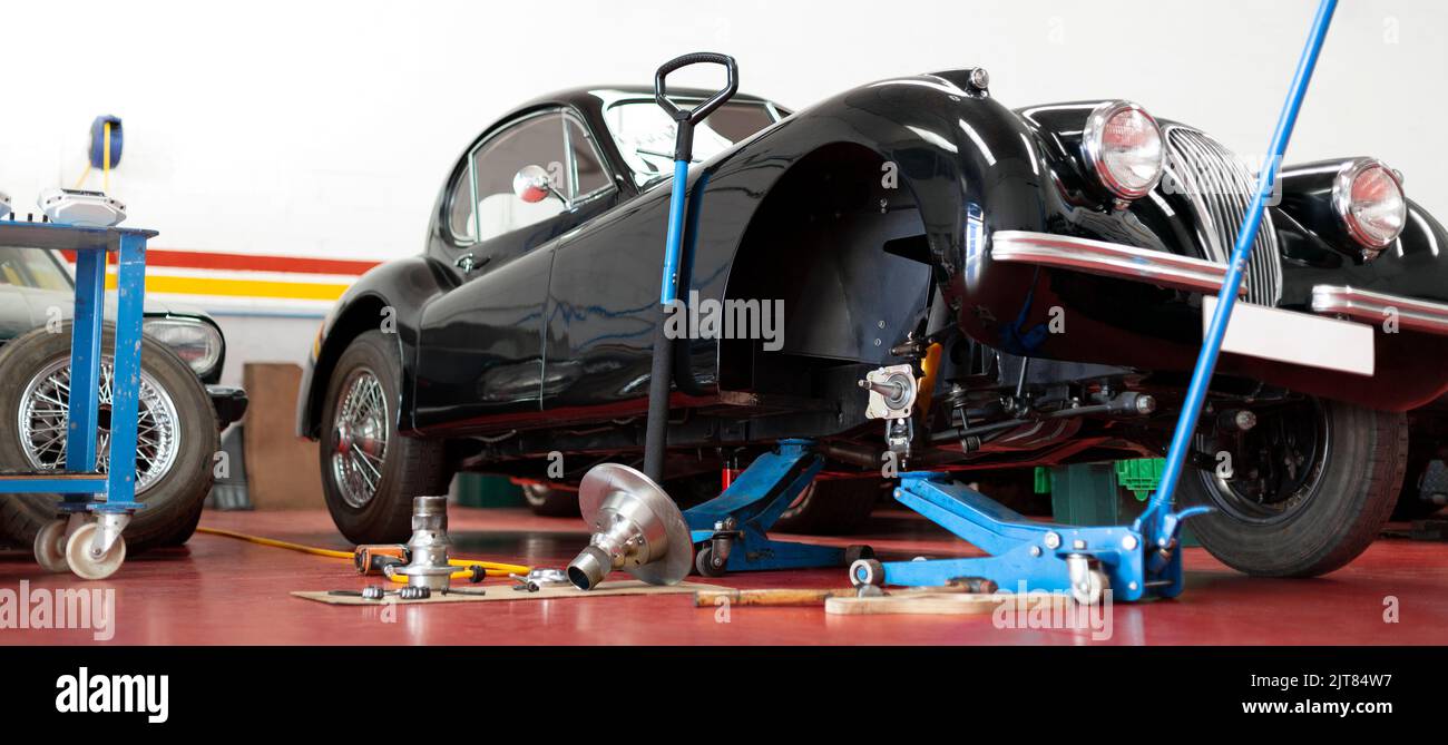 Panoramic view of antique automobile being repaired in the mechanic ...