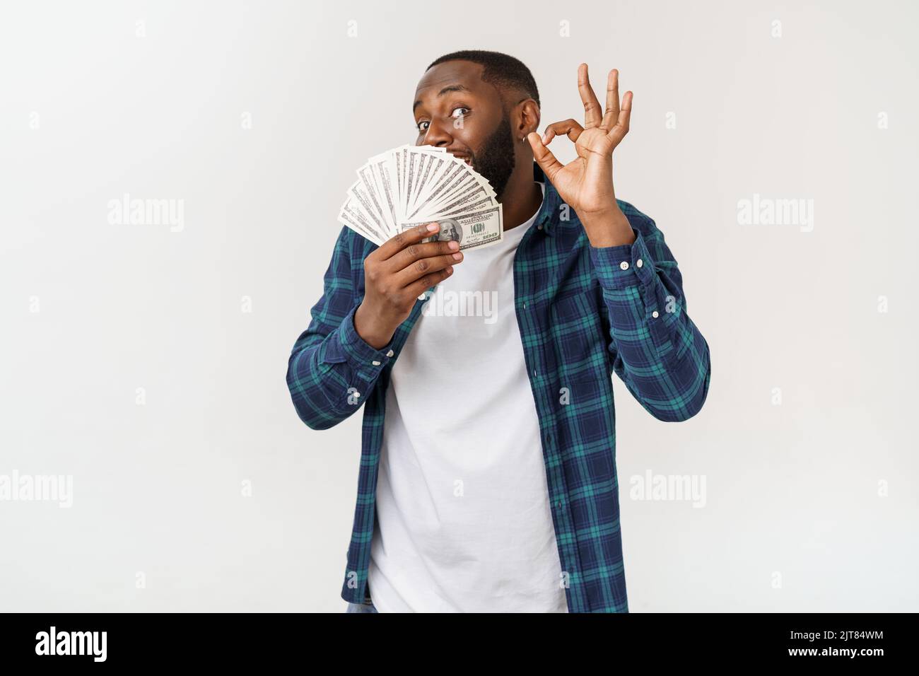 African man holding bank notes happy and surprised cheering expressing ...