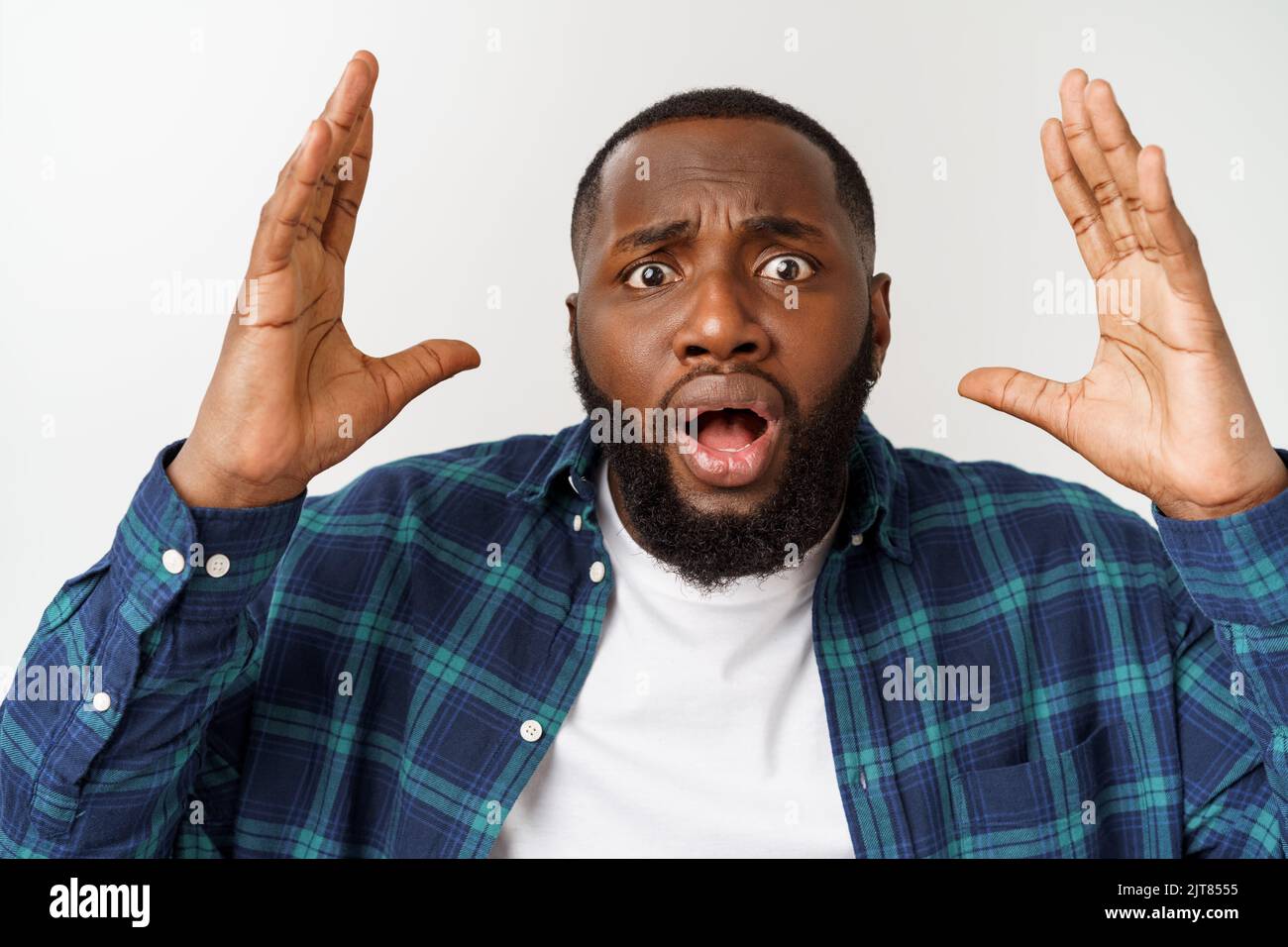 surprised young African American man student staring at camera with ...