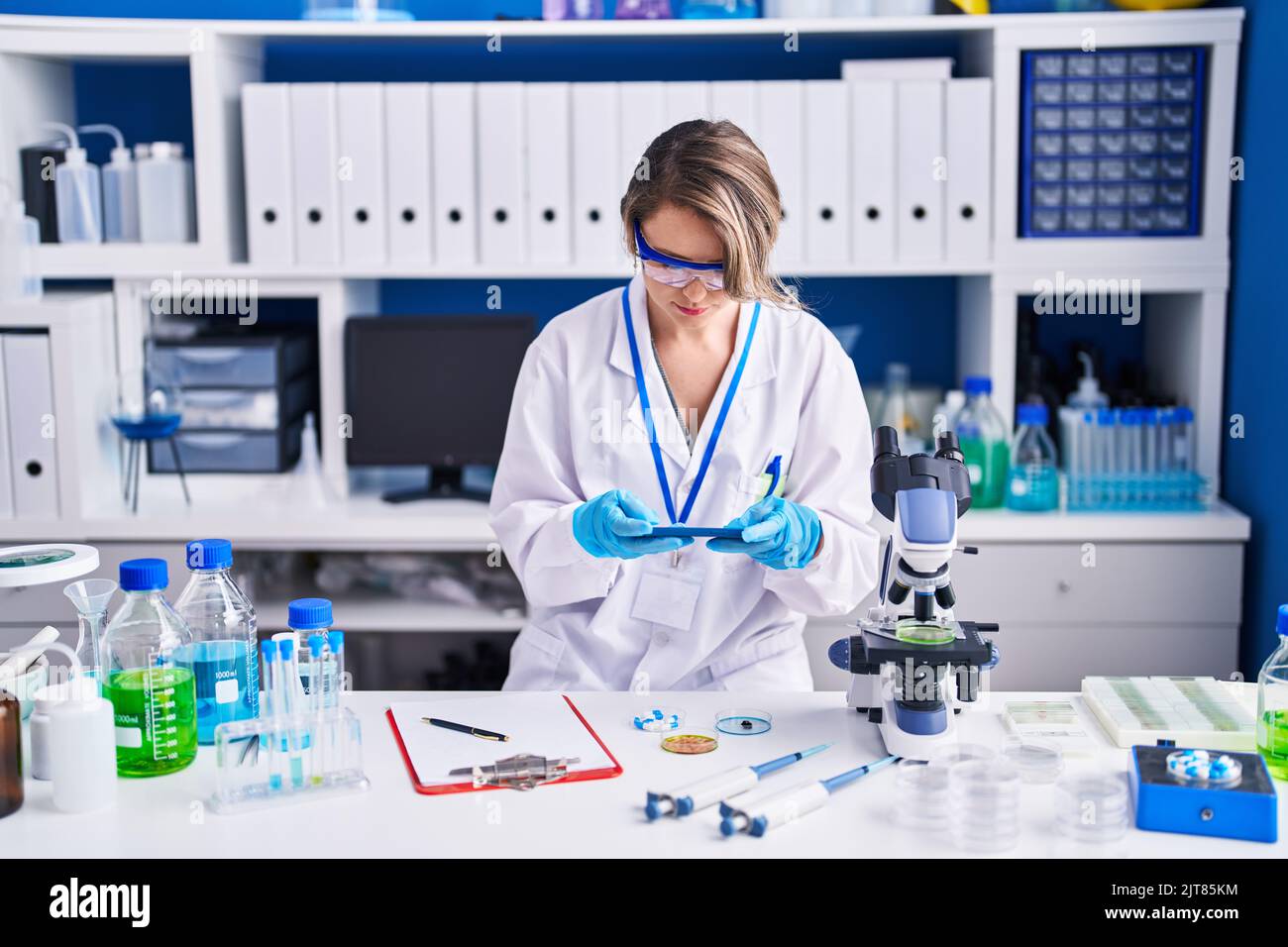 Young woman scientist make photo to pills at laboratory Stock Photo - Alamy