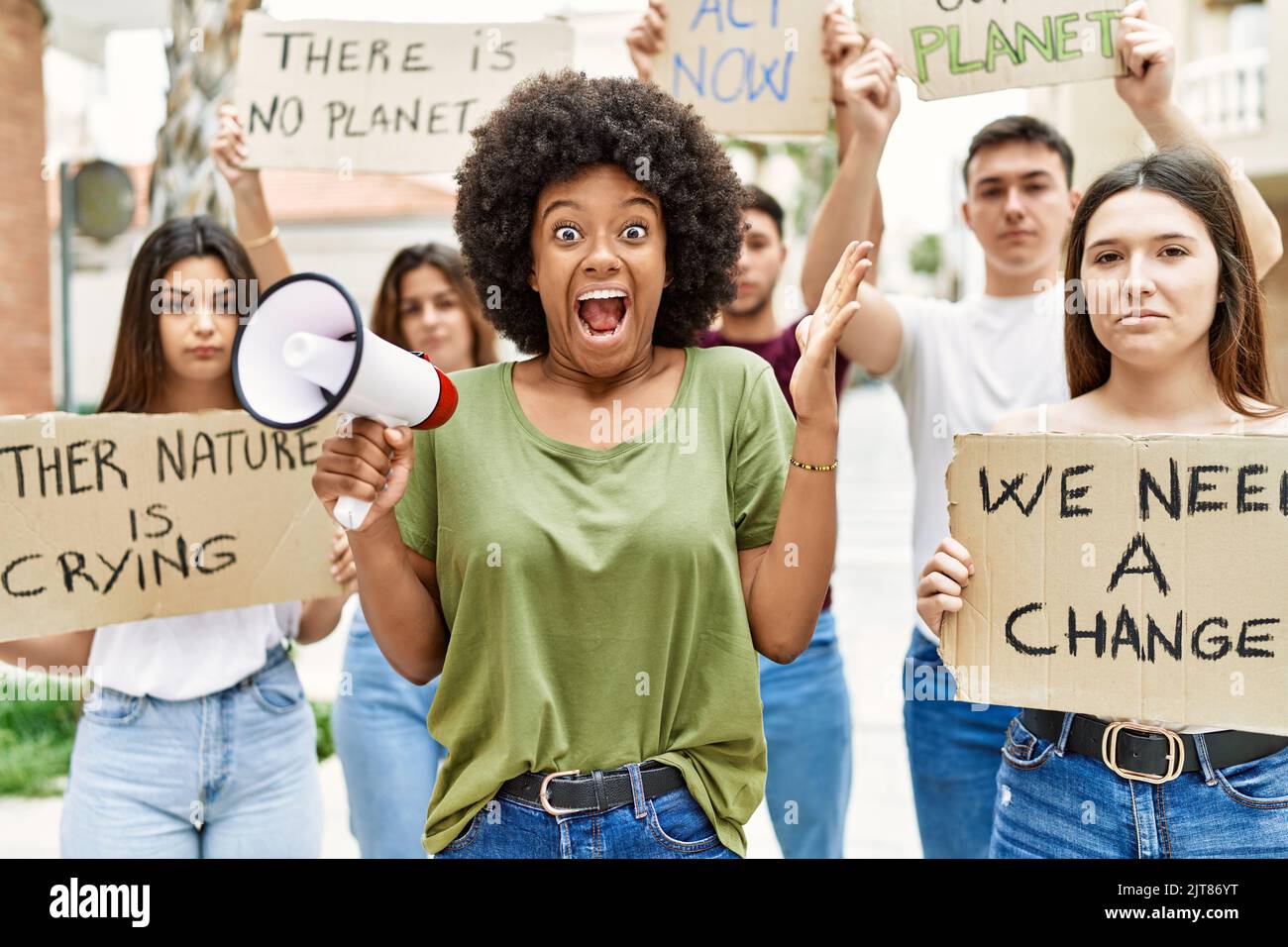 Group of young friends protesting and giving slogans at the street ...