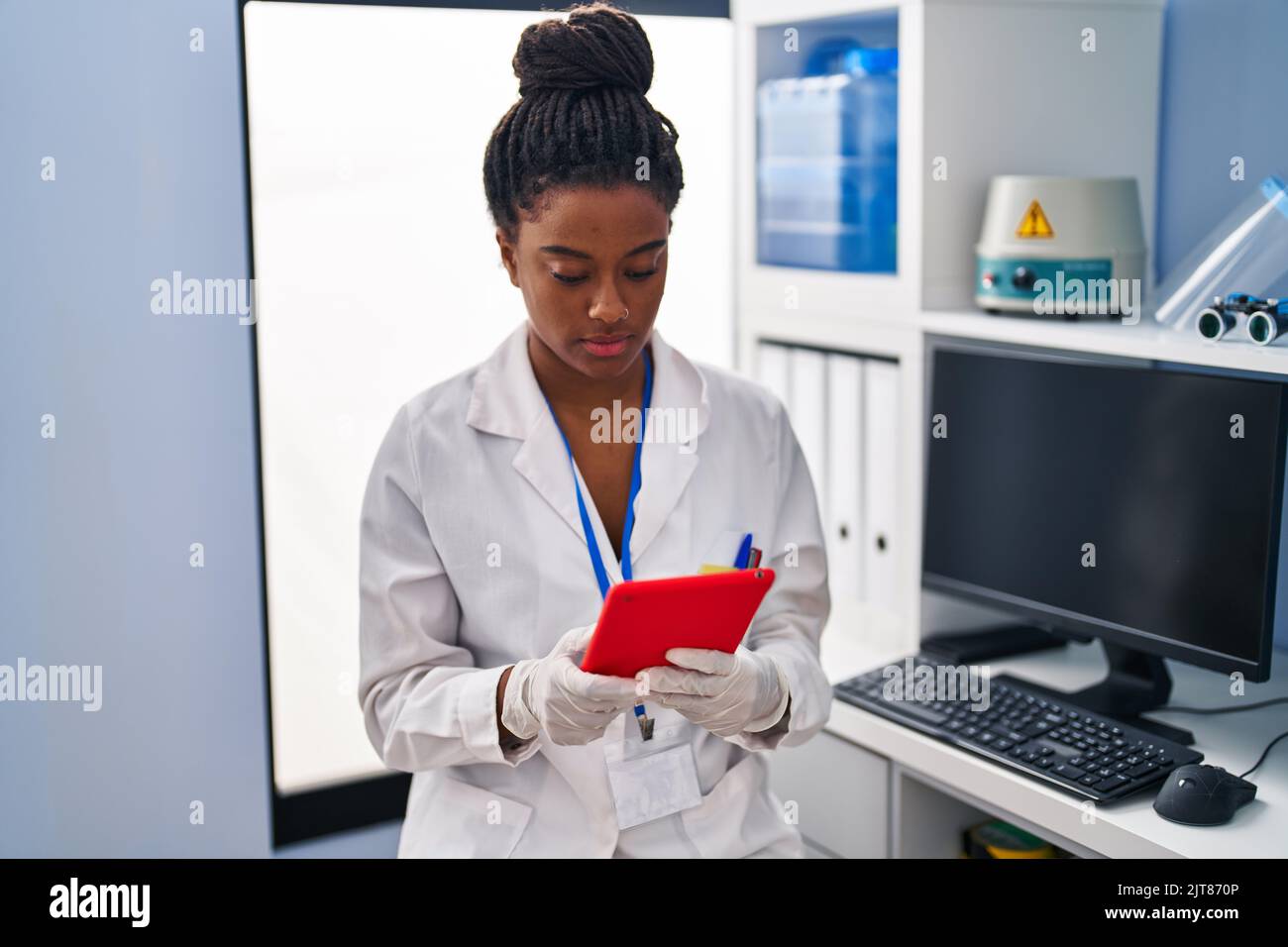 African american woman scientist using touchpad working at laboratory Stock Photo - Alamy