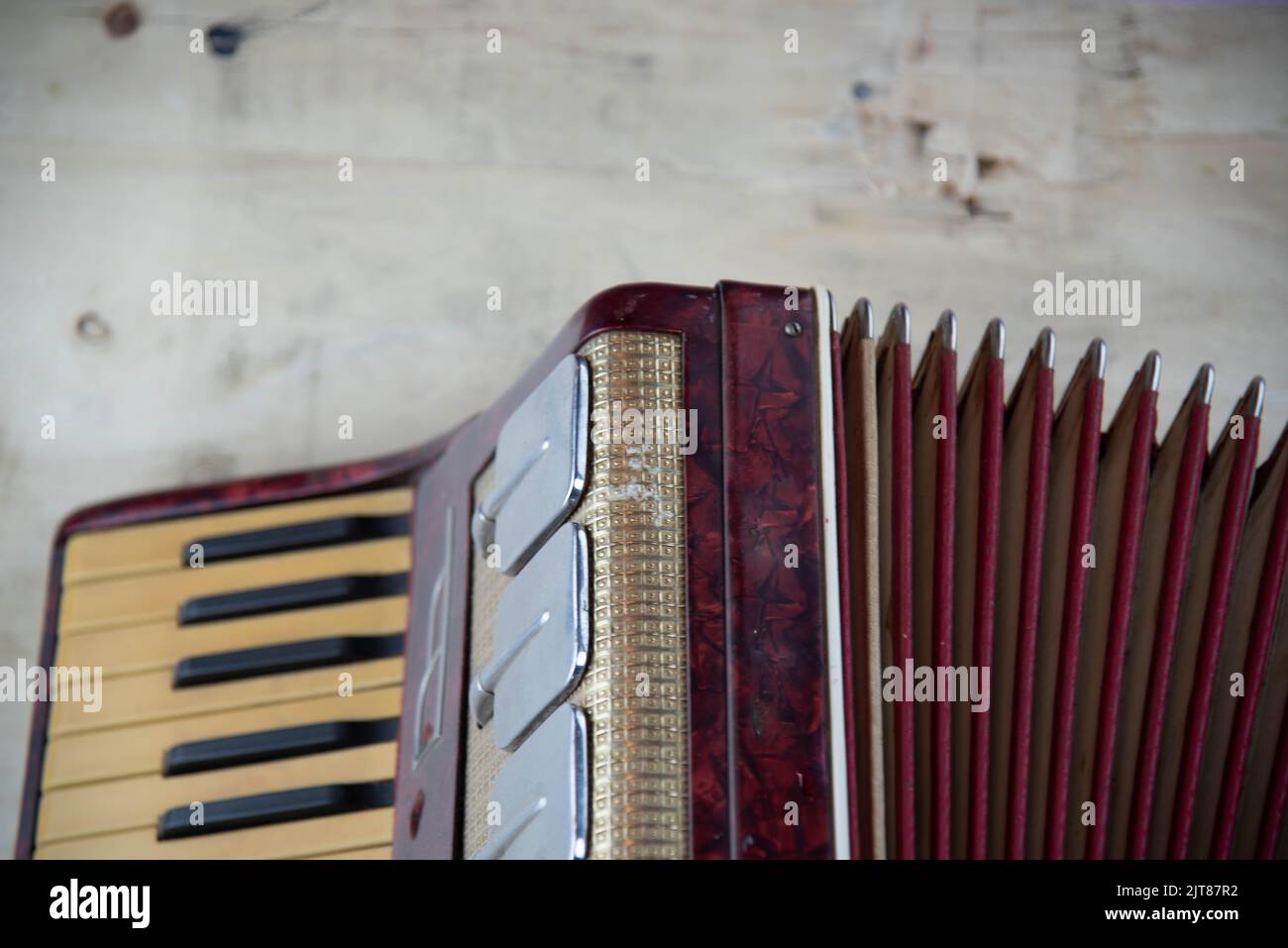 Old red accordion. Wind musical instrument. Old concertina. Musical ...