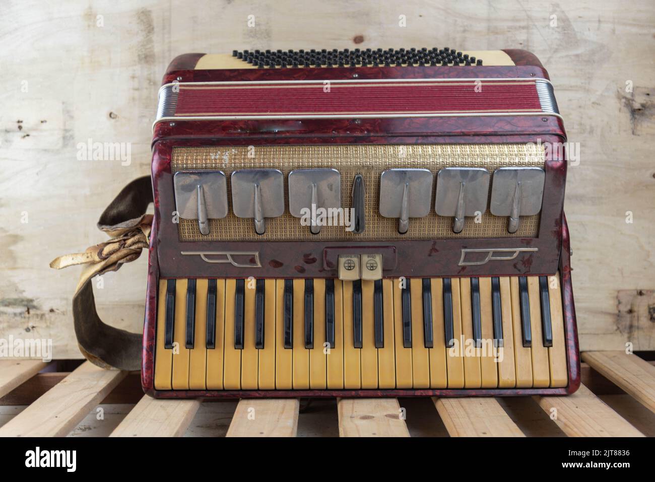 Old red accordion. Wind musical instrument. Old concertina. Musical ...