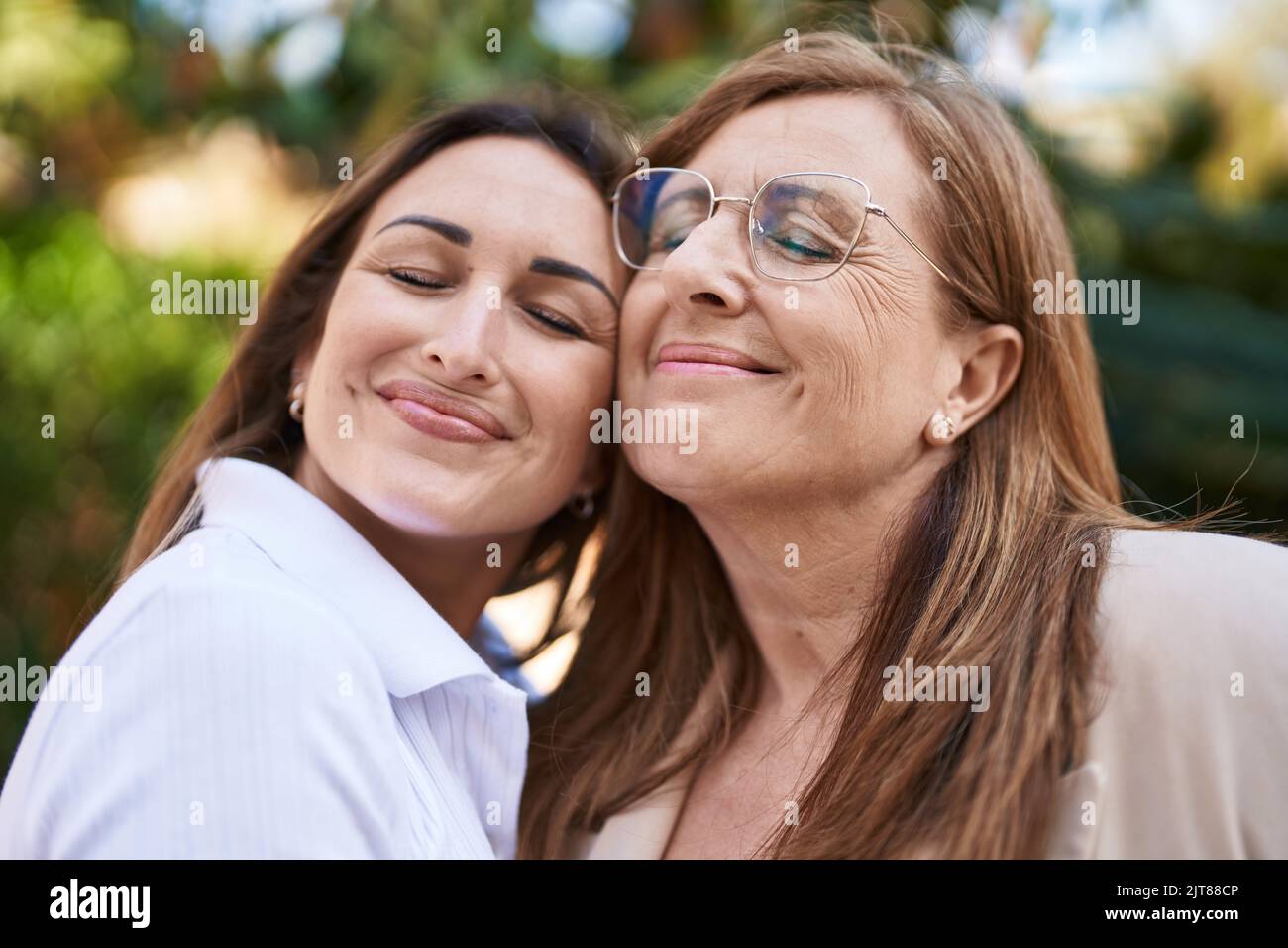 Mother And Daughter Smiling Confident Hugging Each Other At Park Stock