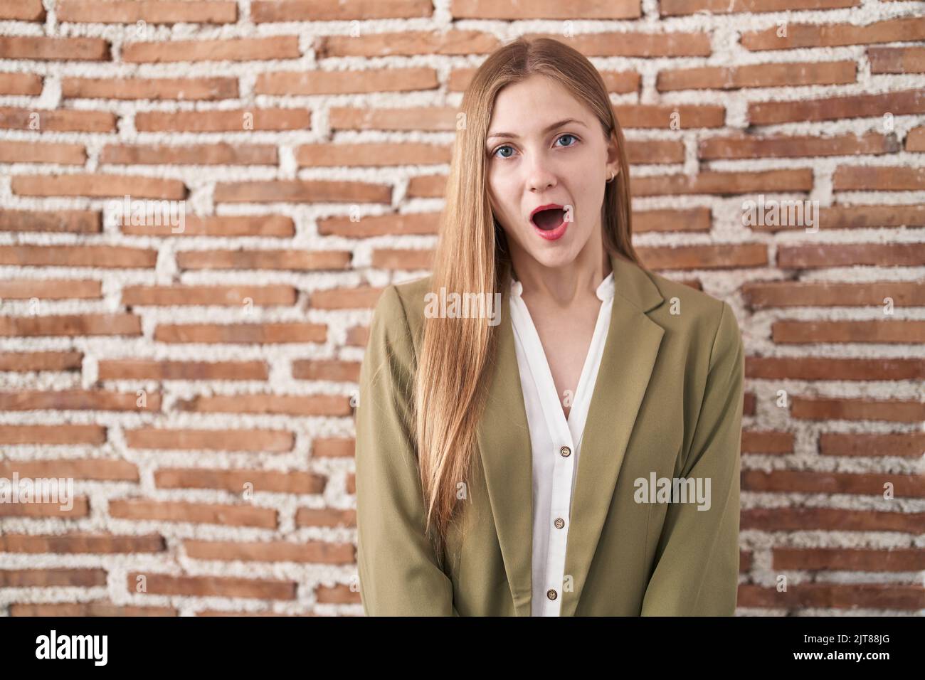 Young Caucasian Woman Standing Over Bricks Wall Background Afraid And