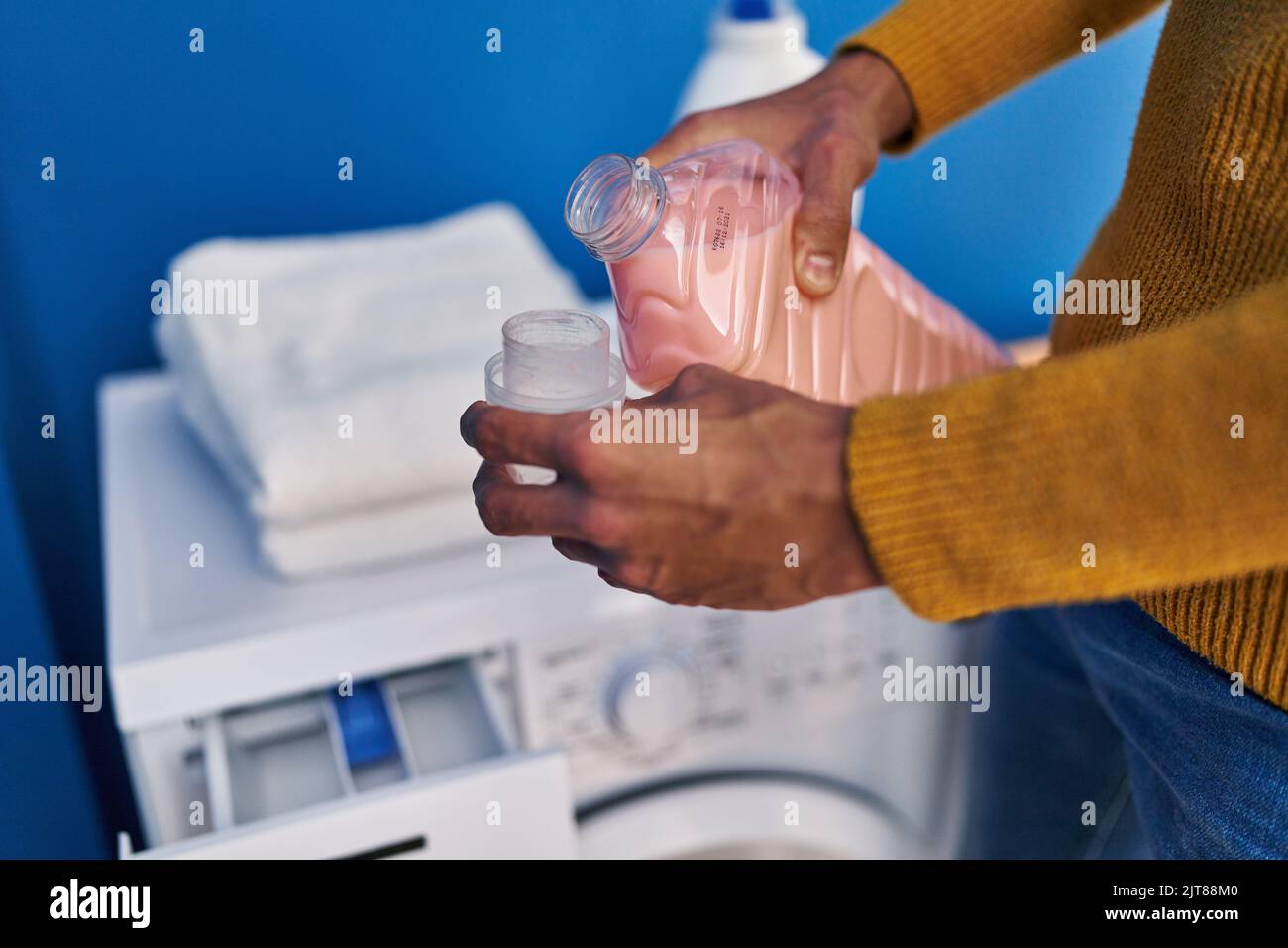 Man pouring laundry detergent hi-res stock photography and images - Alamy