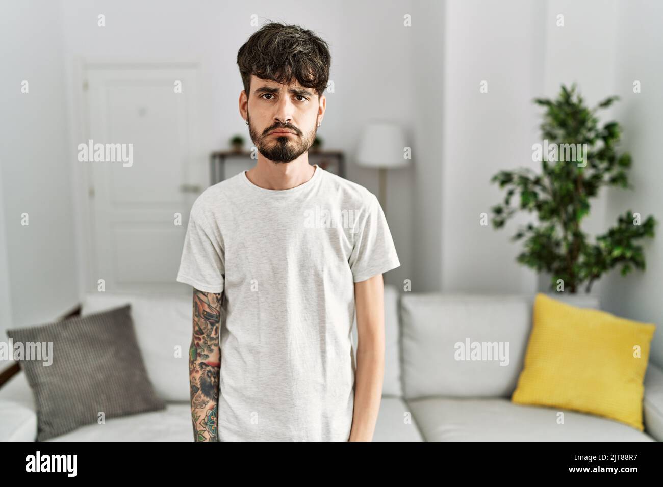 Hispanic man with beard at the living room at home depressed and worry ...