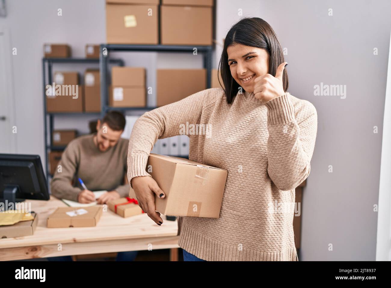 Two young people working at small business ecommerce smiling happy and ...
