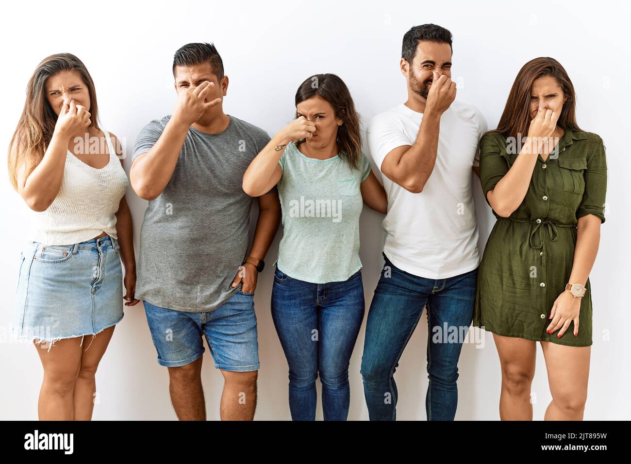Group of young hispanic friends standing together over isolated ...