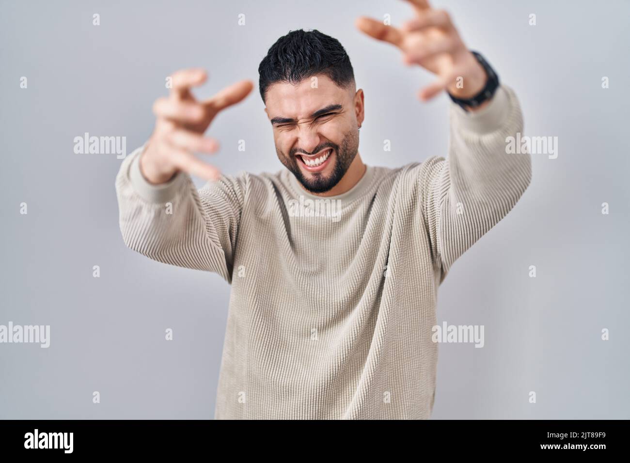 Young handsome man standing over isolated background shouting ...