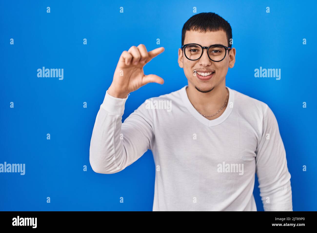 Young Arab Man Wearing Casual White Shirt And Glasses Smiling And
