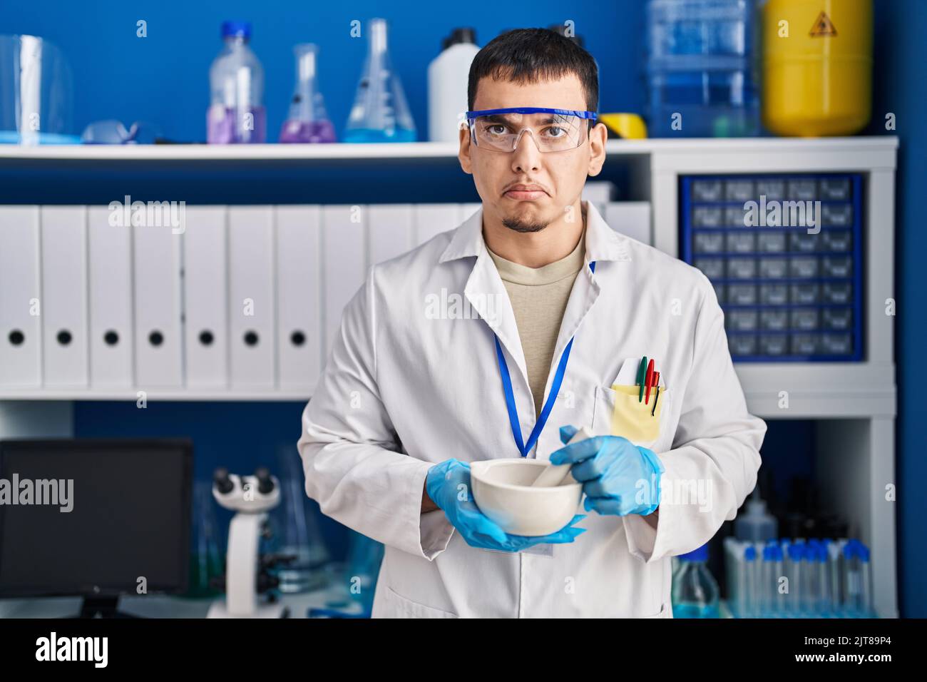 Young arab man working at scientist laboratory depressed and worry for ...