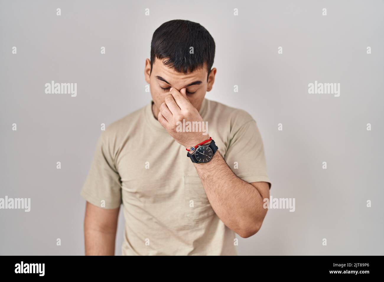Young arab man wearing casual t shirt tired rubbing nose and eyes ...